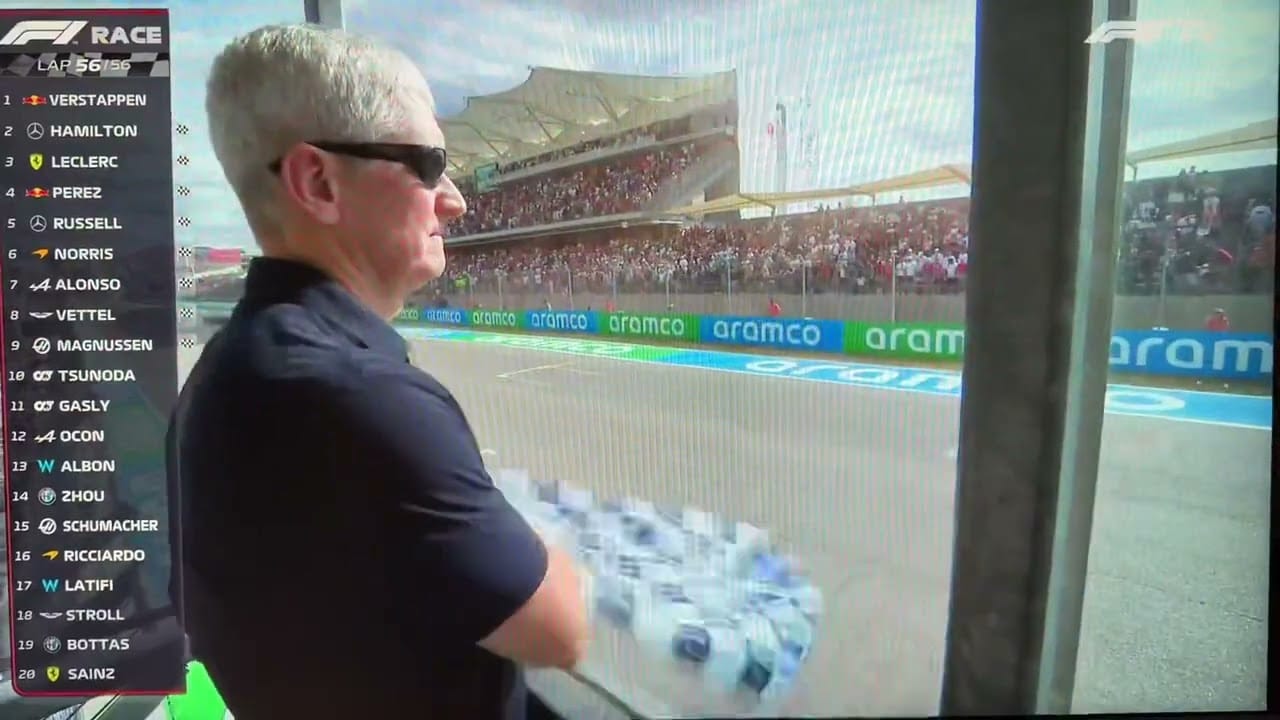 Tim Cook viftar med flaggan på Formel 1